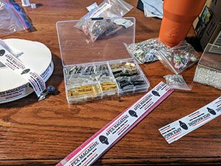 Hard at Work making Kickstarter Exclusive Ribbon Bookmarks - Apex Magazine